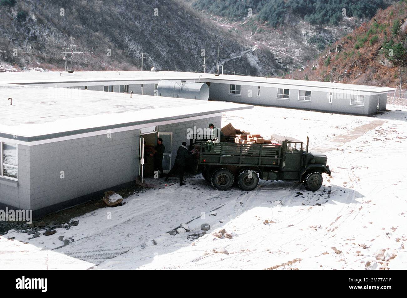 Supplies are unloaded at the consolidated barracks on the Korean ...