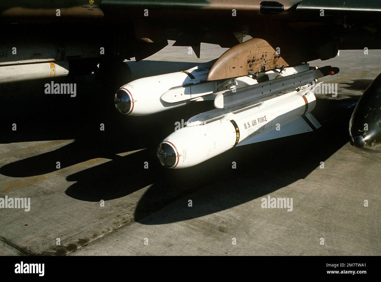 A close-up view of two AGM-65 Maverick air-to-surface missiles mounted beneath the wing of an F ...