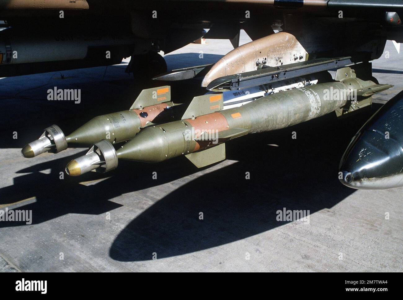 A close-up view of two GBU-12 laser-guided bombs mounted under the wing of an F-4E Phantom II ...