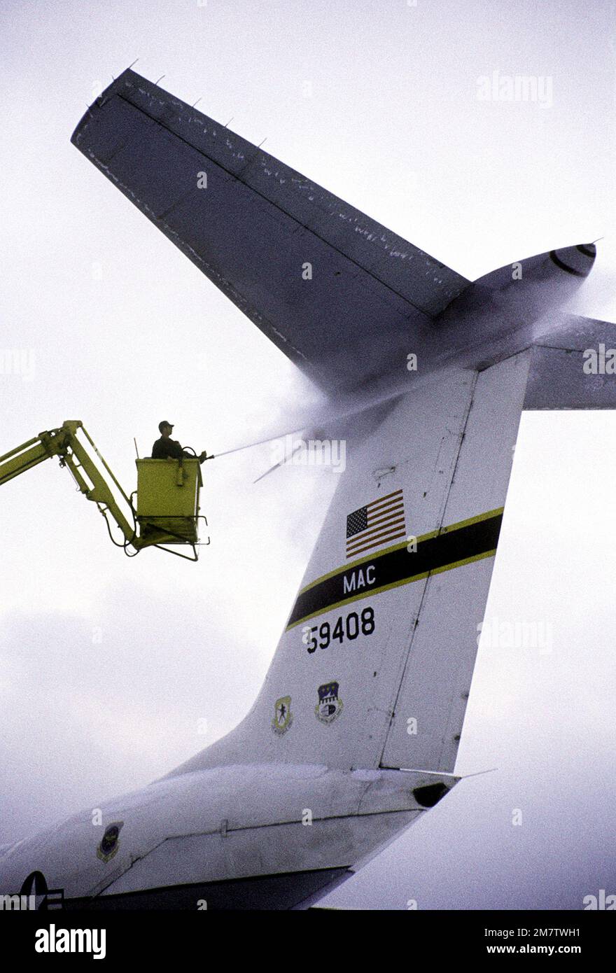 Ground crewmen from the 7350th Air Base Group de-ice a C-141B ...