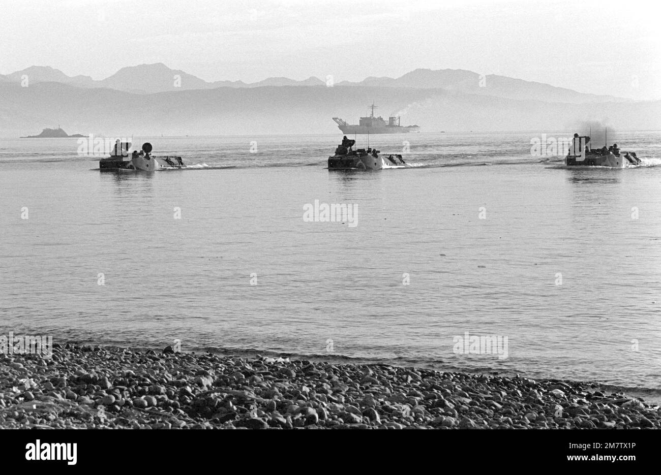 Marine Corps LVTP-7 personnel tracked landing vehicles approach a beach ...