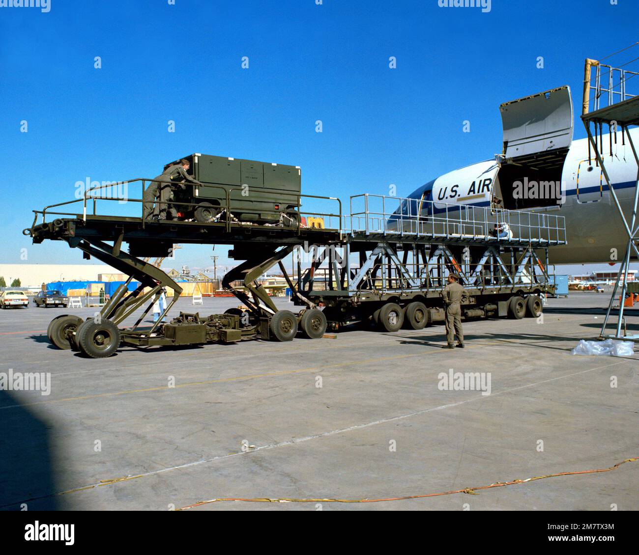 A cargo loading demonstration is given beside a KC-10A Extender ...