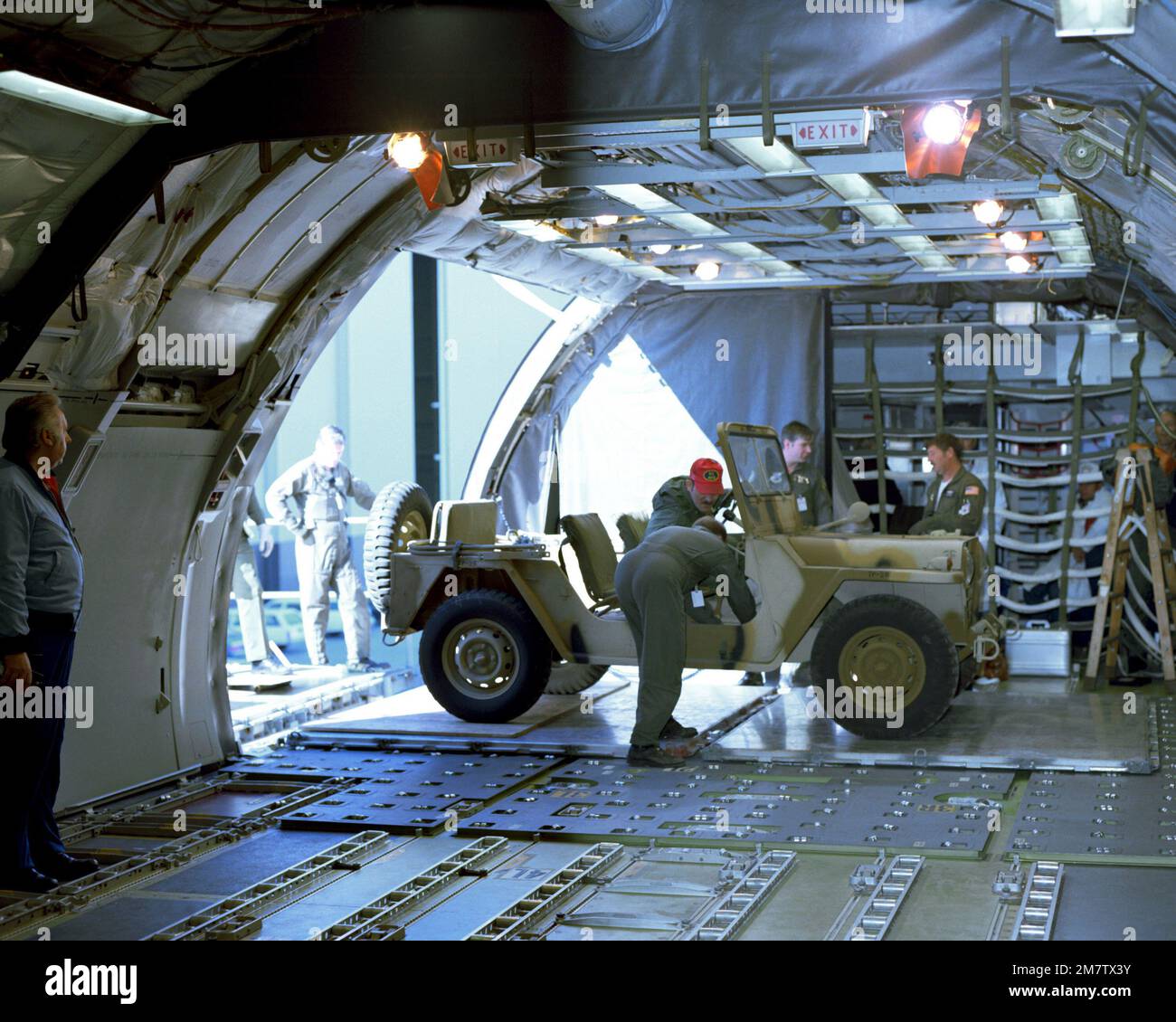A jeep is loaded aboard a KC-10A Extender aircraft during a loading ...