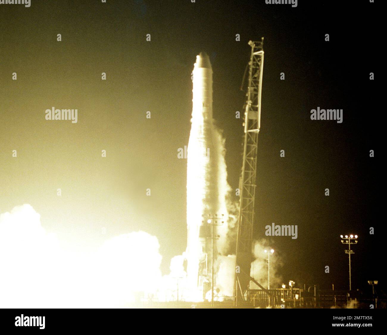 A nighttime view of a GCM-16 Atlas "F" rocket being launched. Base ...