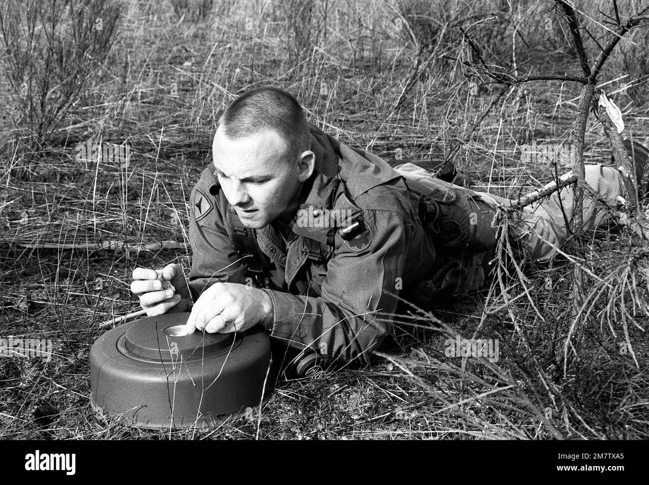 SSGT Larry Kemp of Co. A, 15th Eng. Bn., packs C4 into the well of an M ...