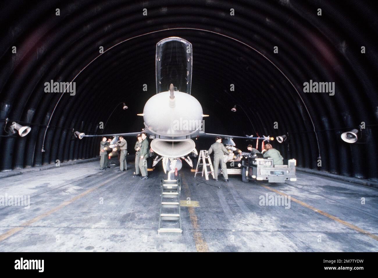 Front view of an F-16 Fighting Falcon aircraft as men from the 8th ...