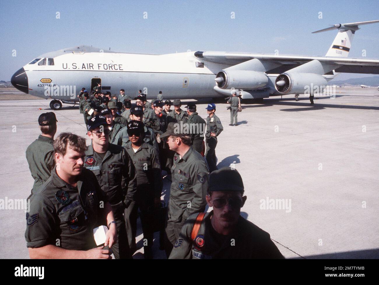 Cargo and troops are off loaded from a C-141 Starlifter aircraft during ...