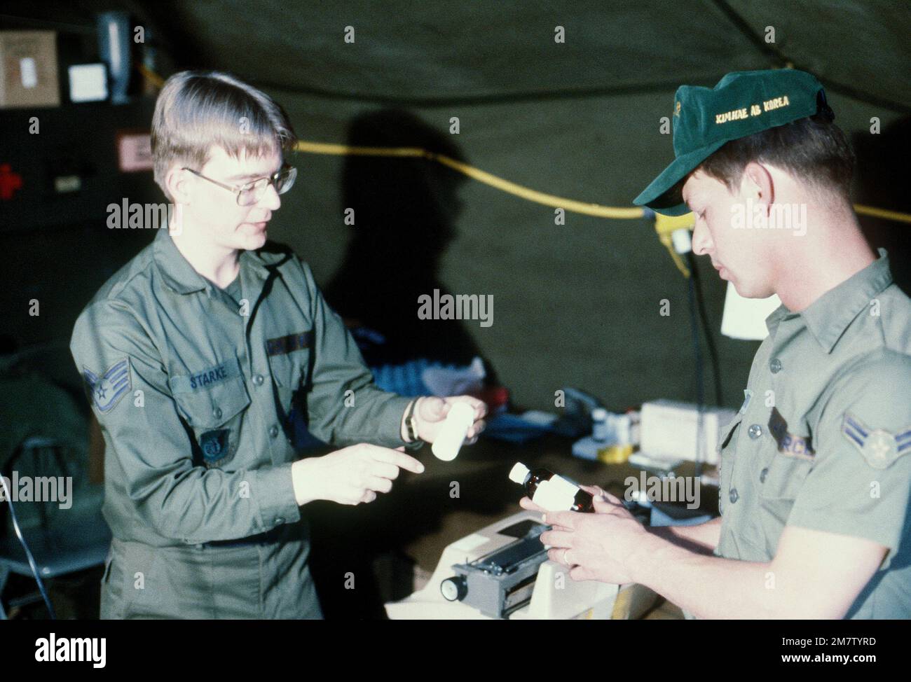SSGT Michael Starke takes a prescription from A1C Timothy Scrivner ...