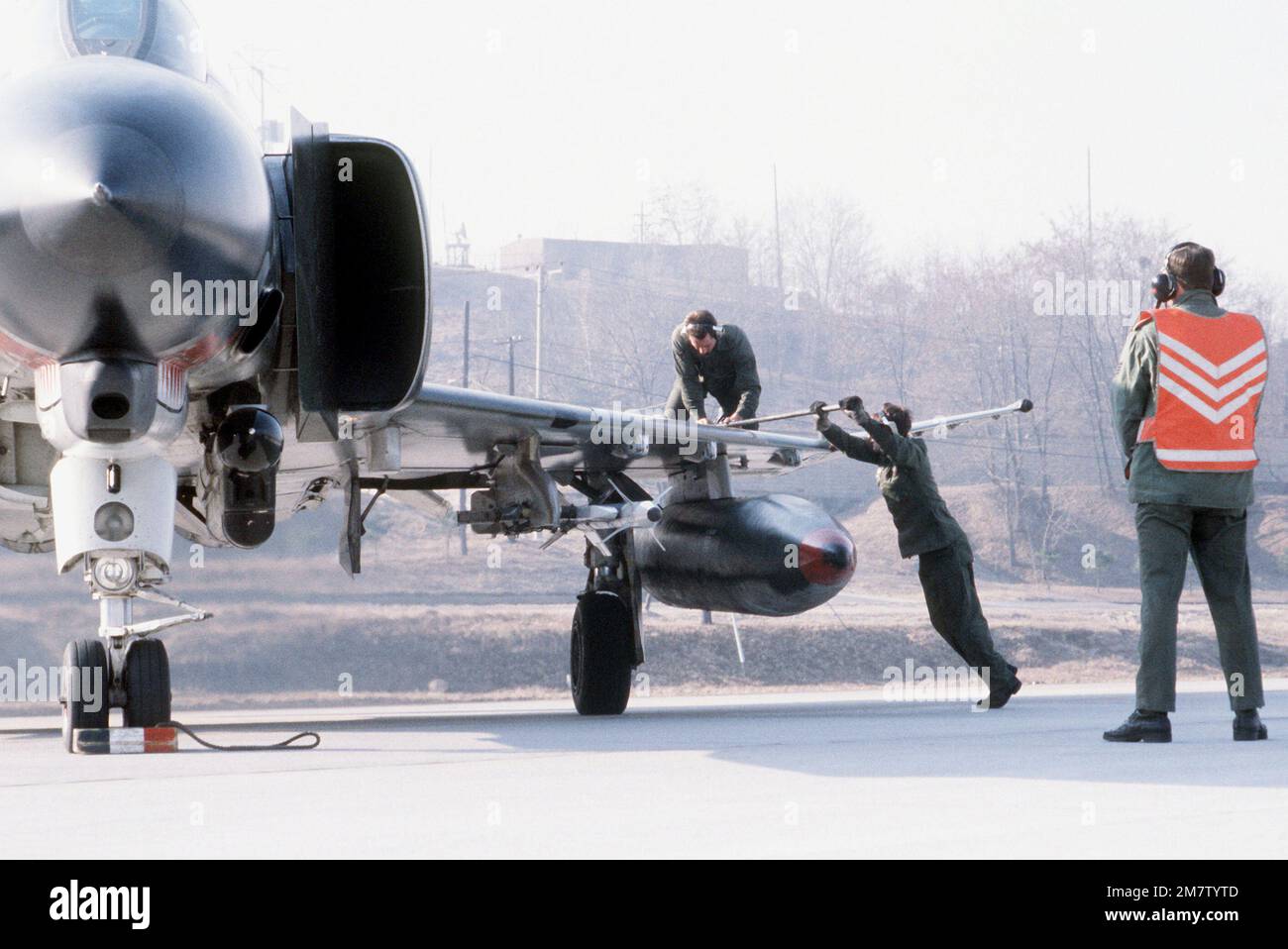 Personnel from the 36th Tactical Fighter Squadron service an F-4 ...