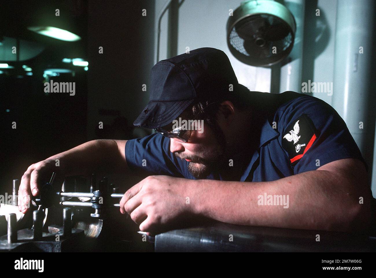Machinery Repairman 3rd Class Stephen Hack takes a valve measurement ...