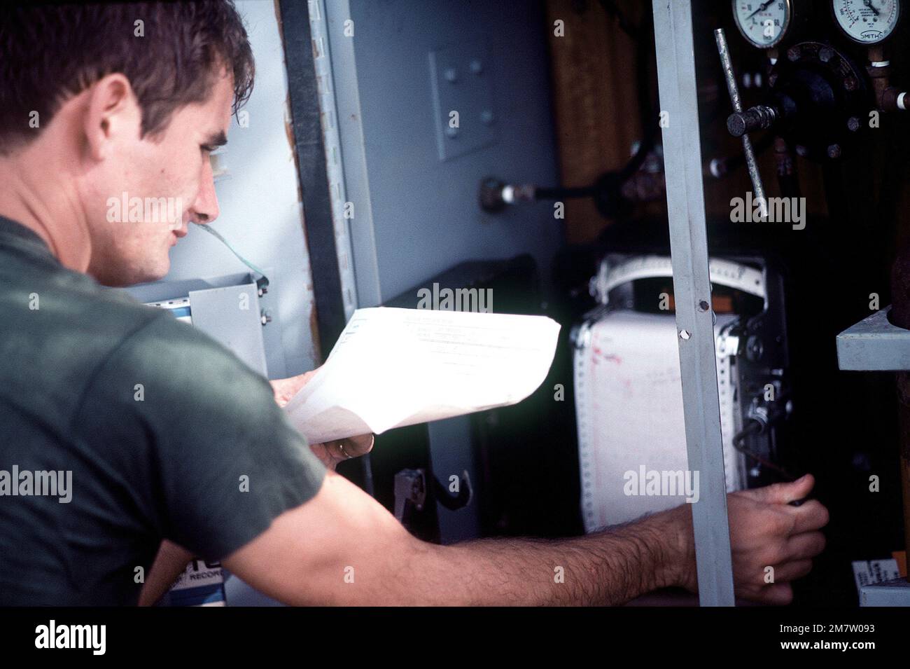 A crewman aboard the surveying ship USNS CHAUVENET (T-AGS-29) checks an ...