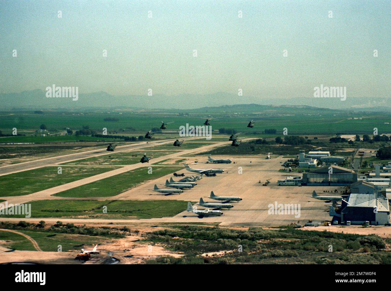 An air-to-air view of Spanish helicopters over the airfield. Base: Rota ...