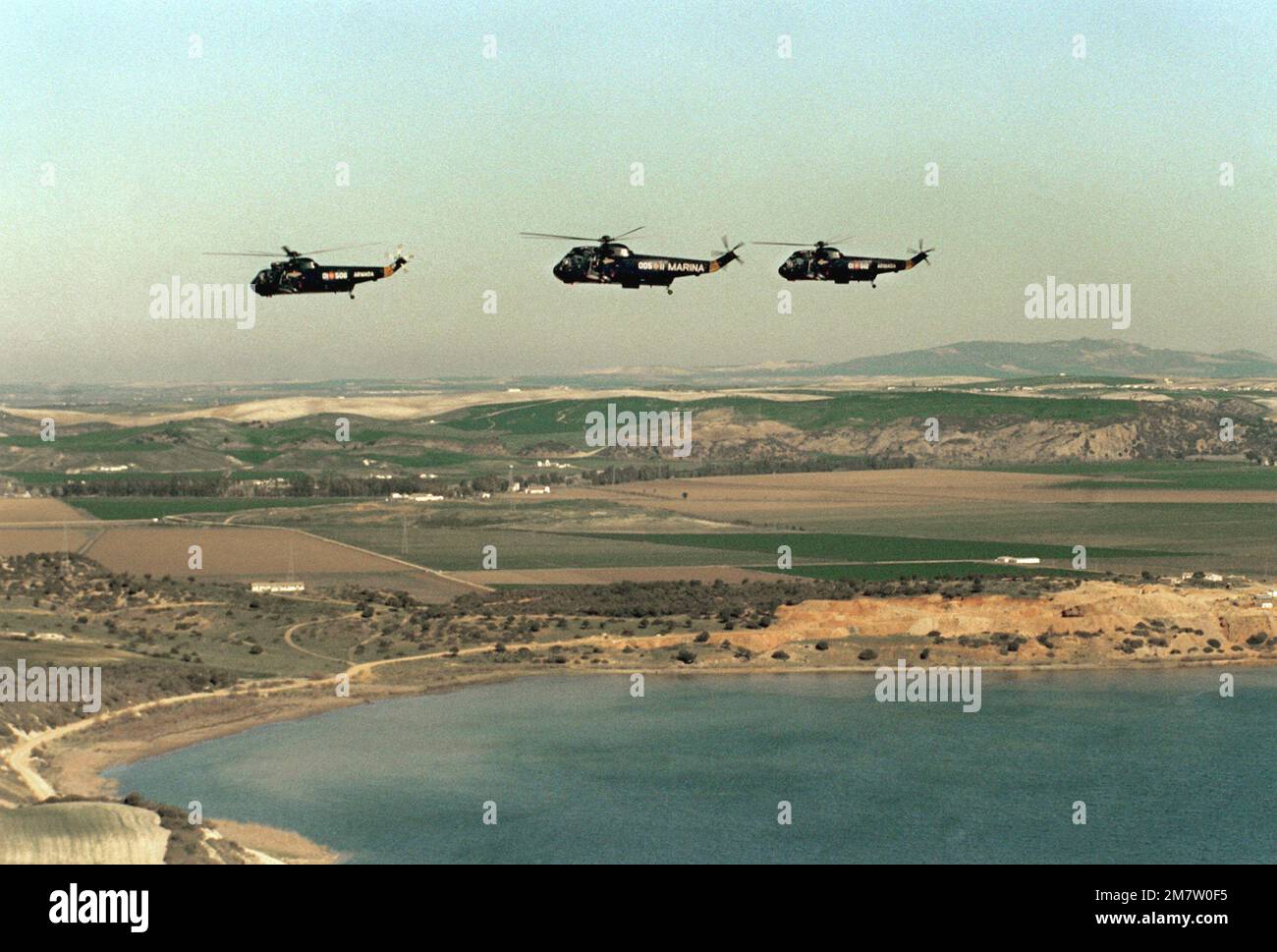 An air-to-air left side view of three Spanish SH-3 Sea King helicopters ...