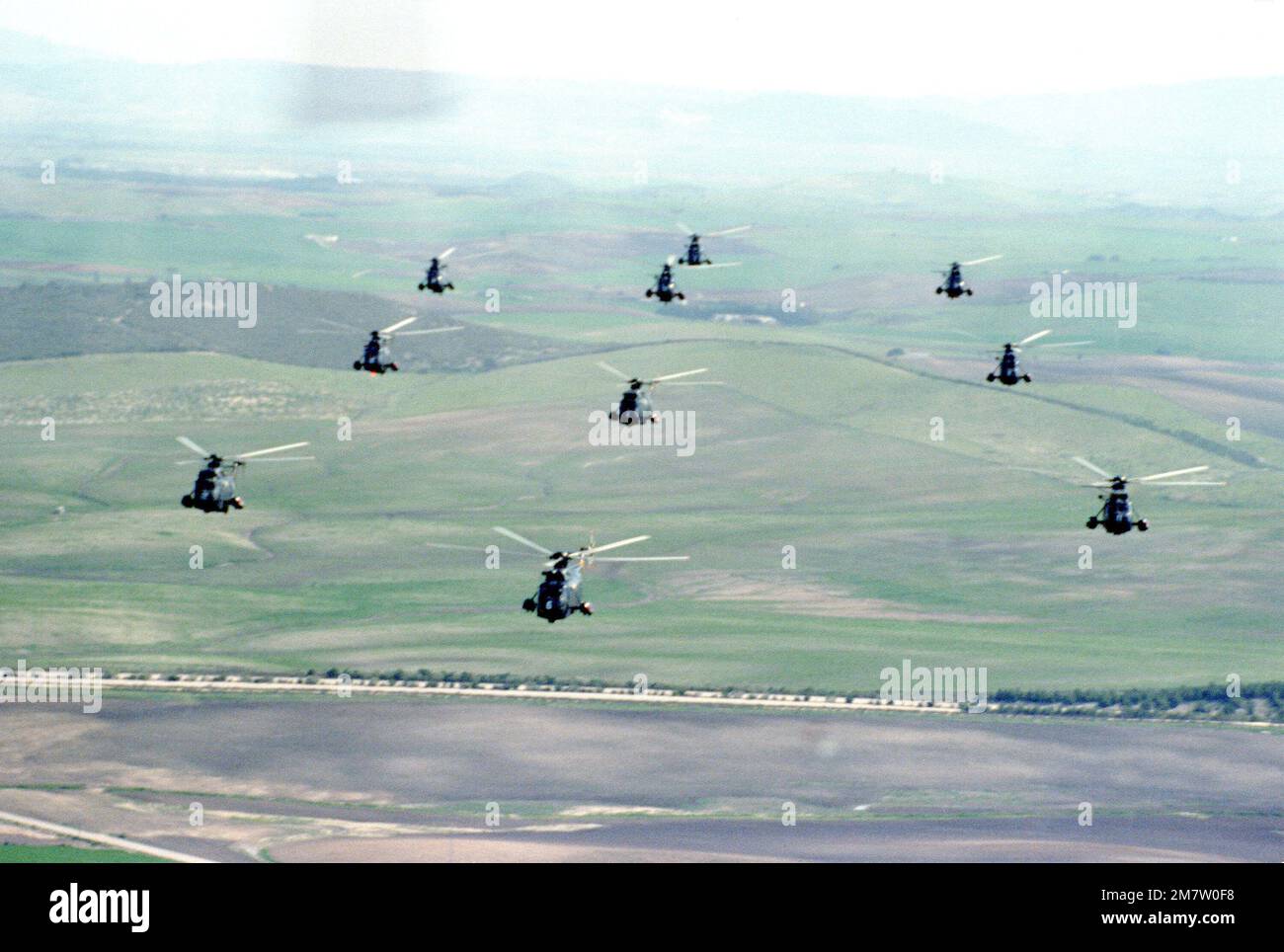An air-to-air front view of 10 Spanish helicopters in flight ...