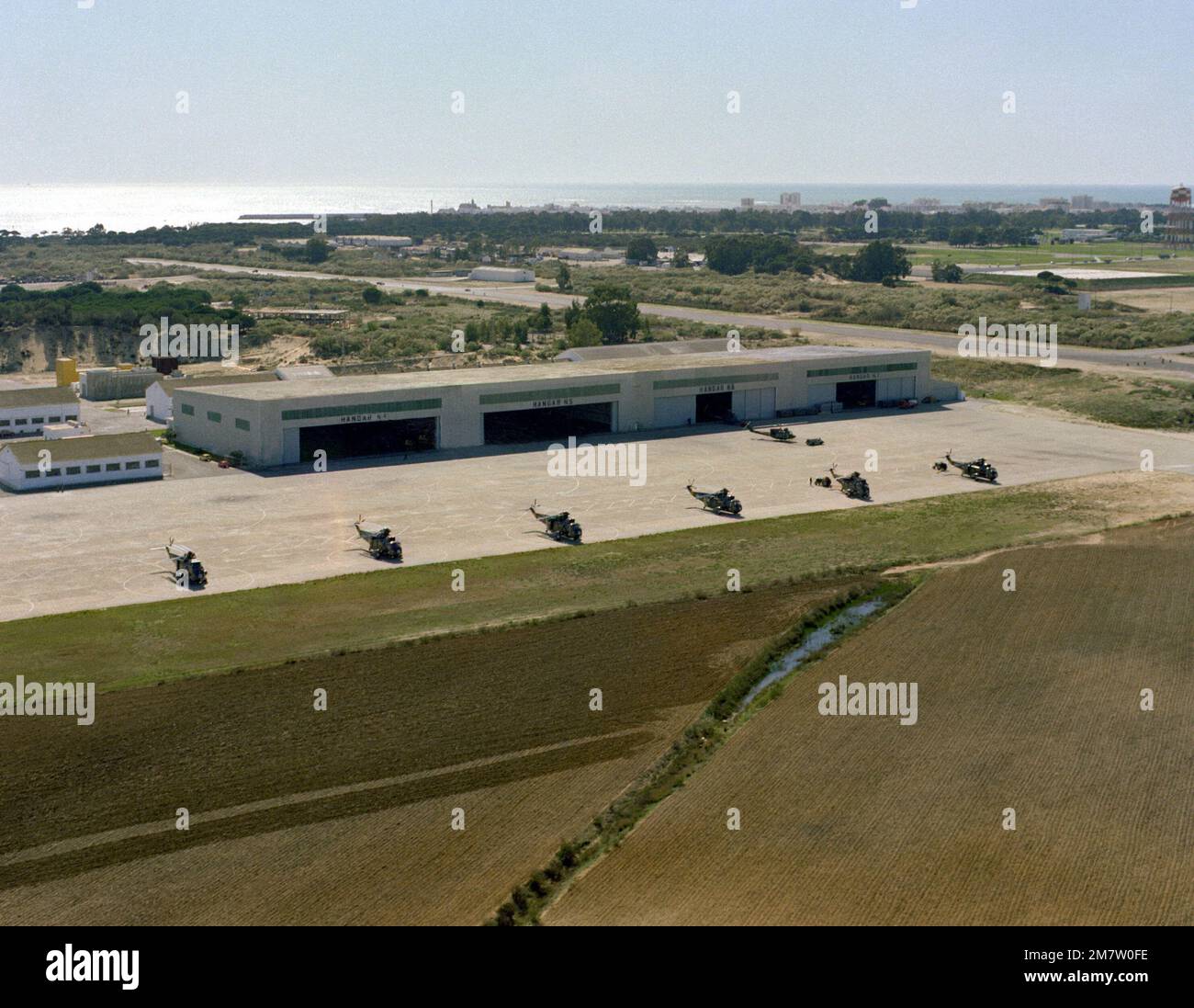 An aerial view of Spanish helicopters parked in front of a hangar. Base ...