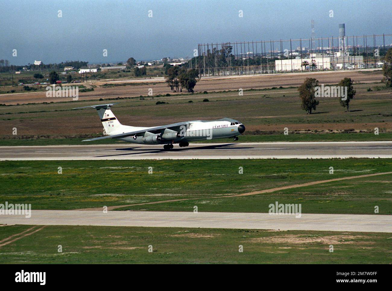 A right side view of a C-141 Starlifter aircraft lifting off the runway ...