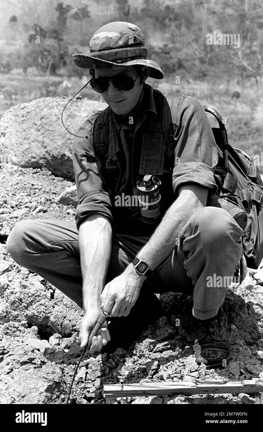 A member of a US Navy Explosive Ordnance Disposal unit prepares to ...
