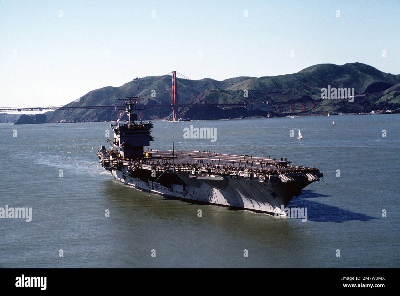Aircraft carrier passing under golden hi-res stock photography and ...