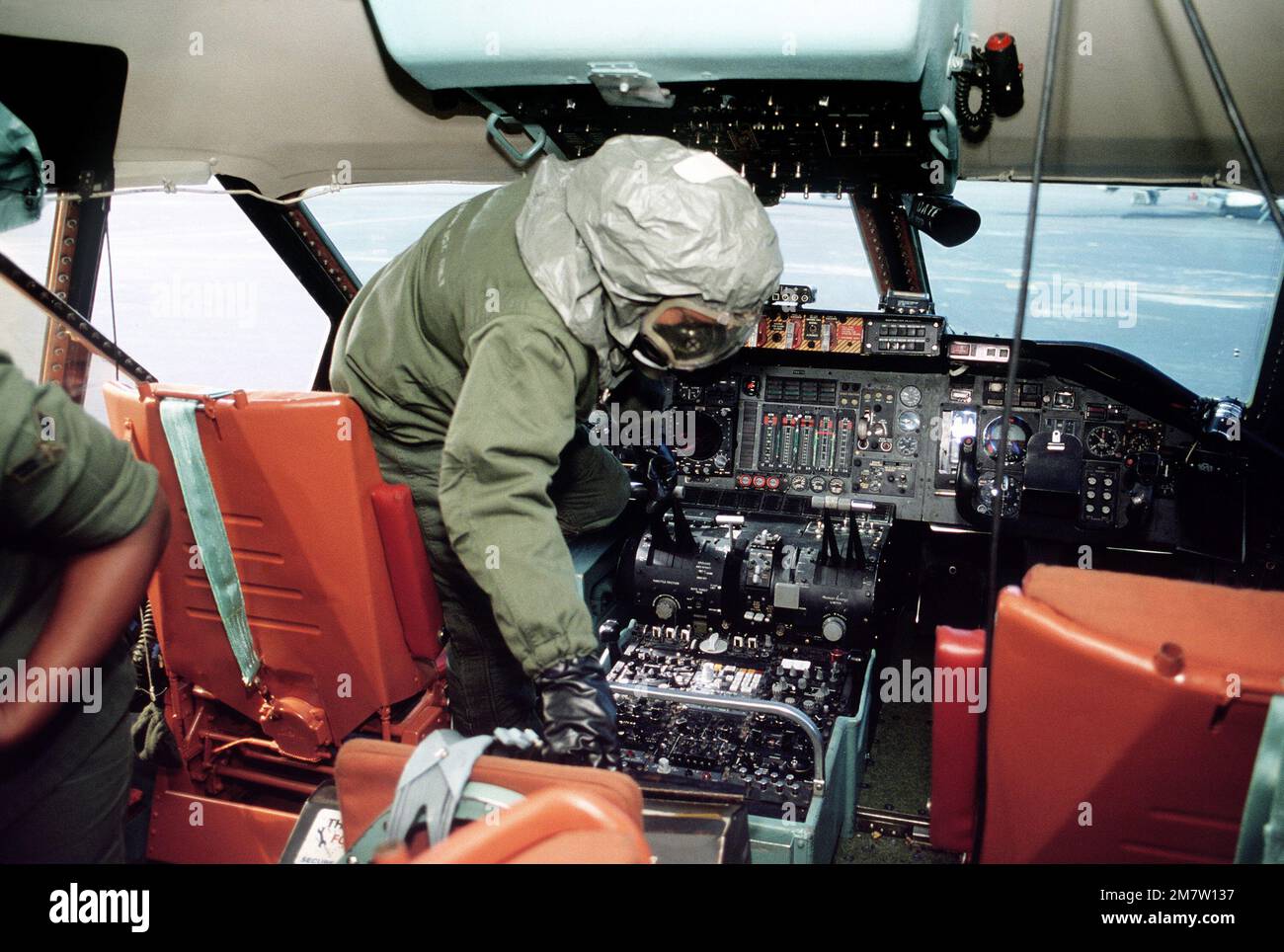 Maintenance personnel change an altitude indicator in the cockpit of a ...