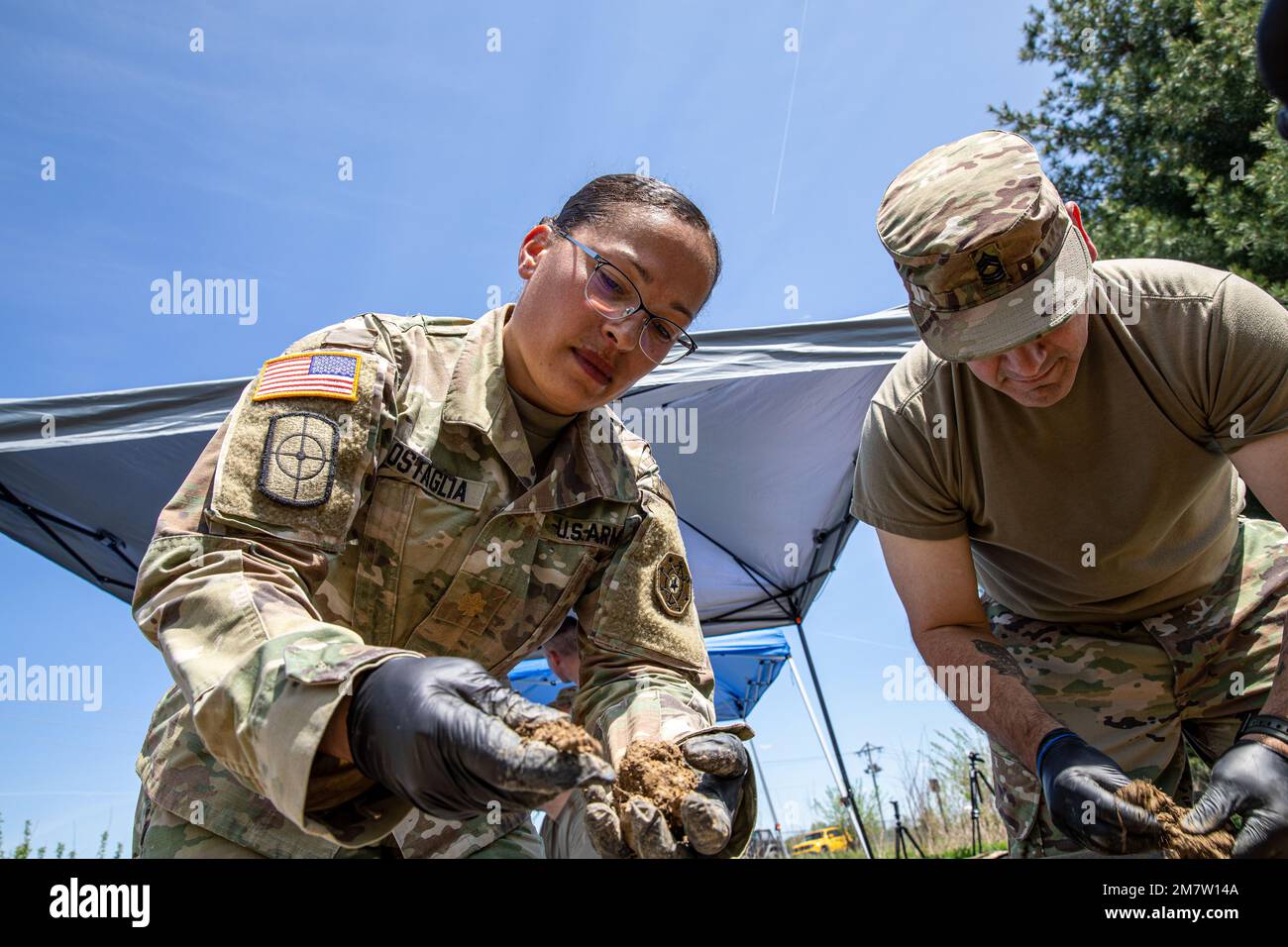 U.S. Army Reserve Maj. Yazmin Lostaglia and a fellow Soldier carefully ...