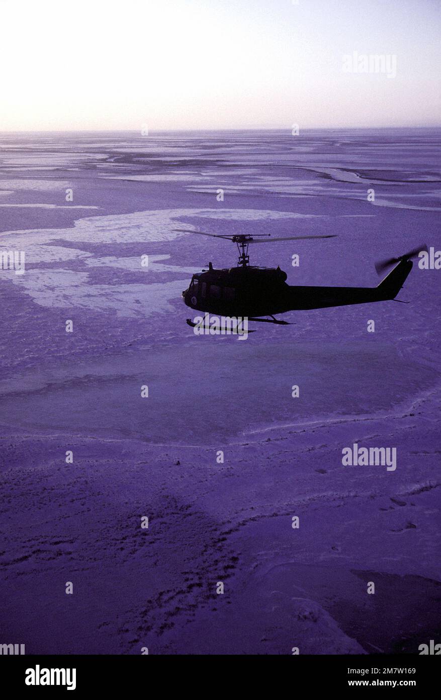 Left side air-to-air view of a UH-1H Iroquois helicopter preparing to ...