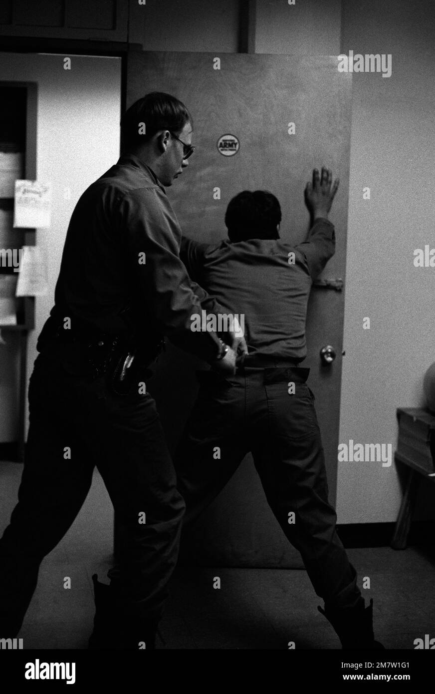 SPC Brian Redford, a military policeman, removes a suspect's belt after ...