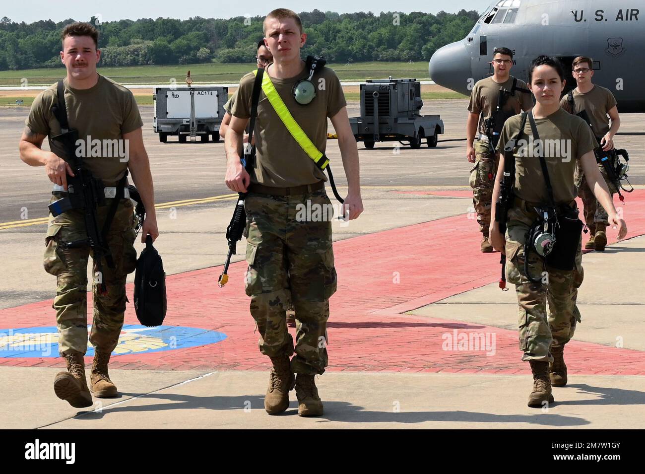 Maintainers assigned to the 19th Airlift Wing walk off the flightline ...