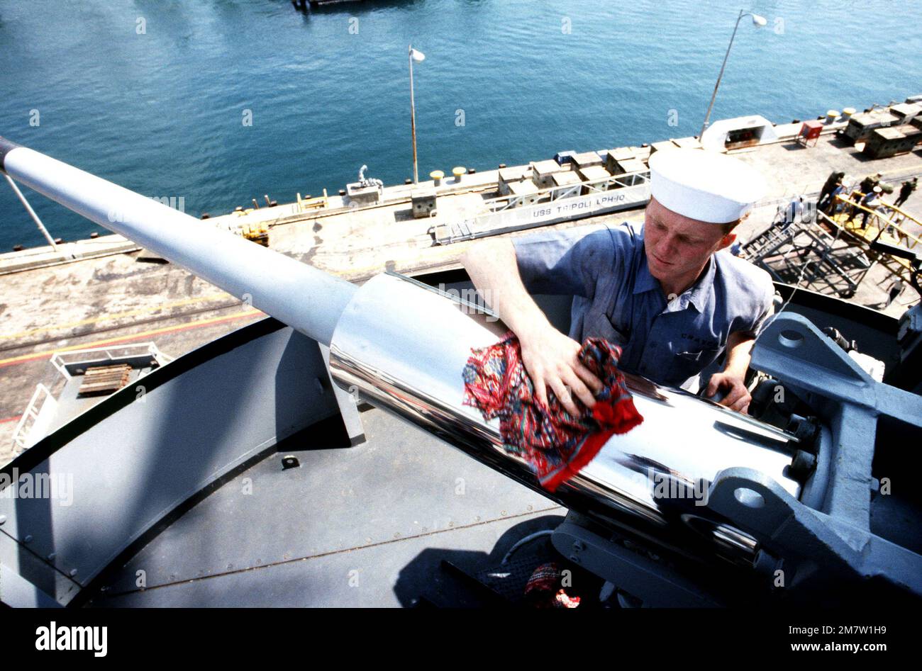 GUNNER's Mate 3rd Class (GMG3) James G. Craycroft polishes the Mark 33 ...