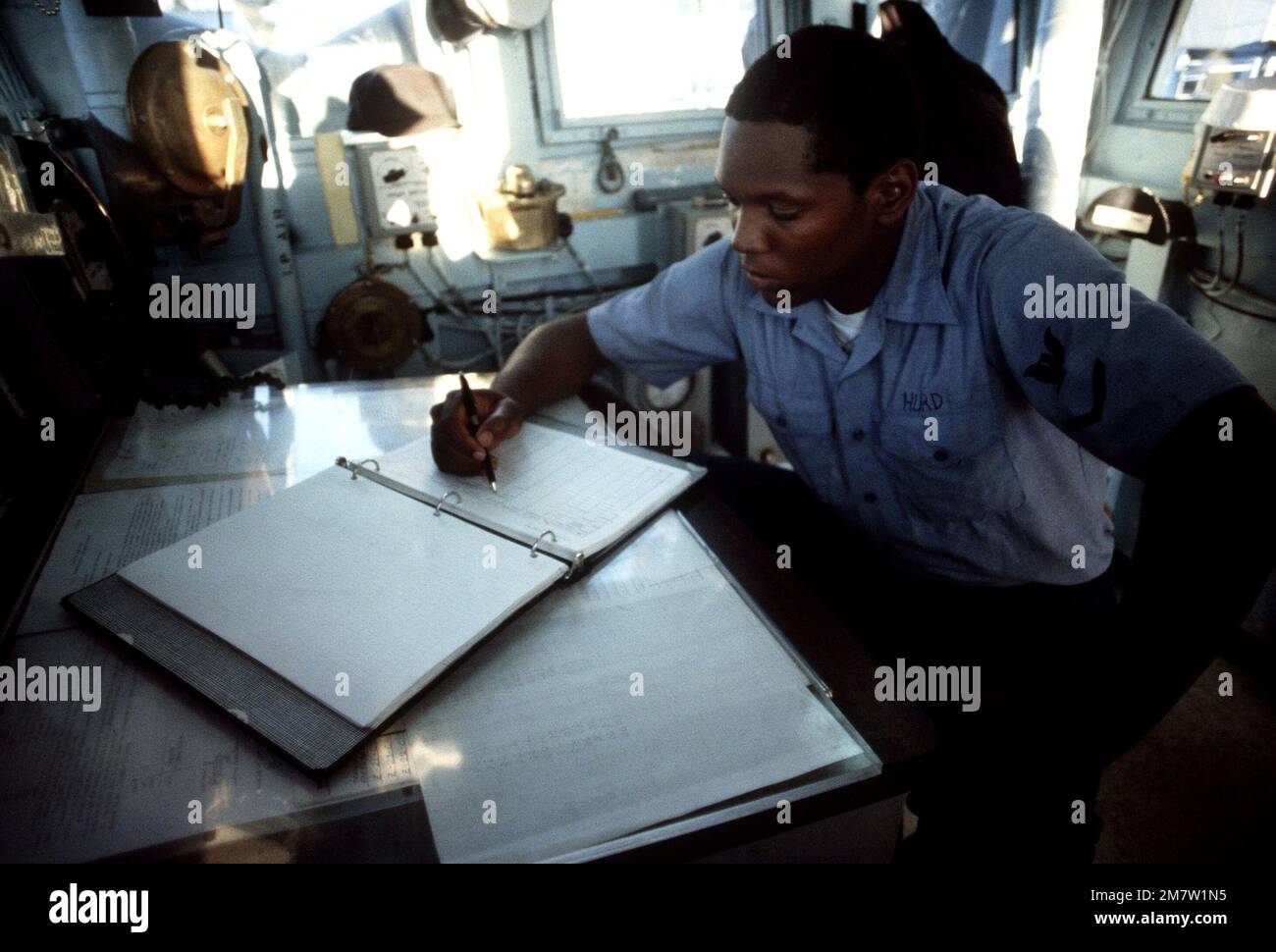 Signalman 3rd Class (SM3) Darryl L. Hurd contemplates log additions ...