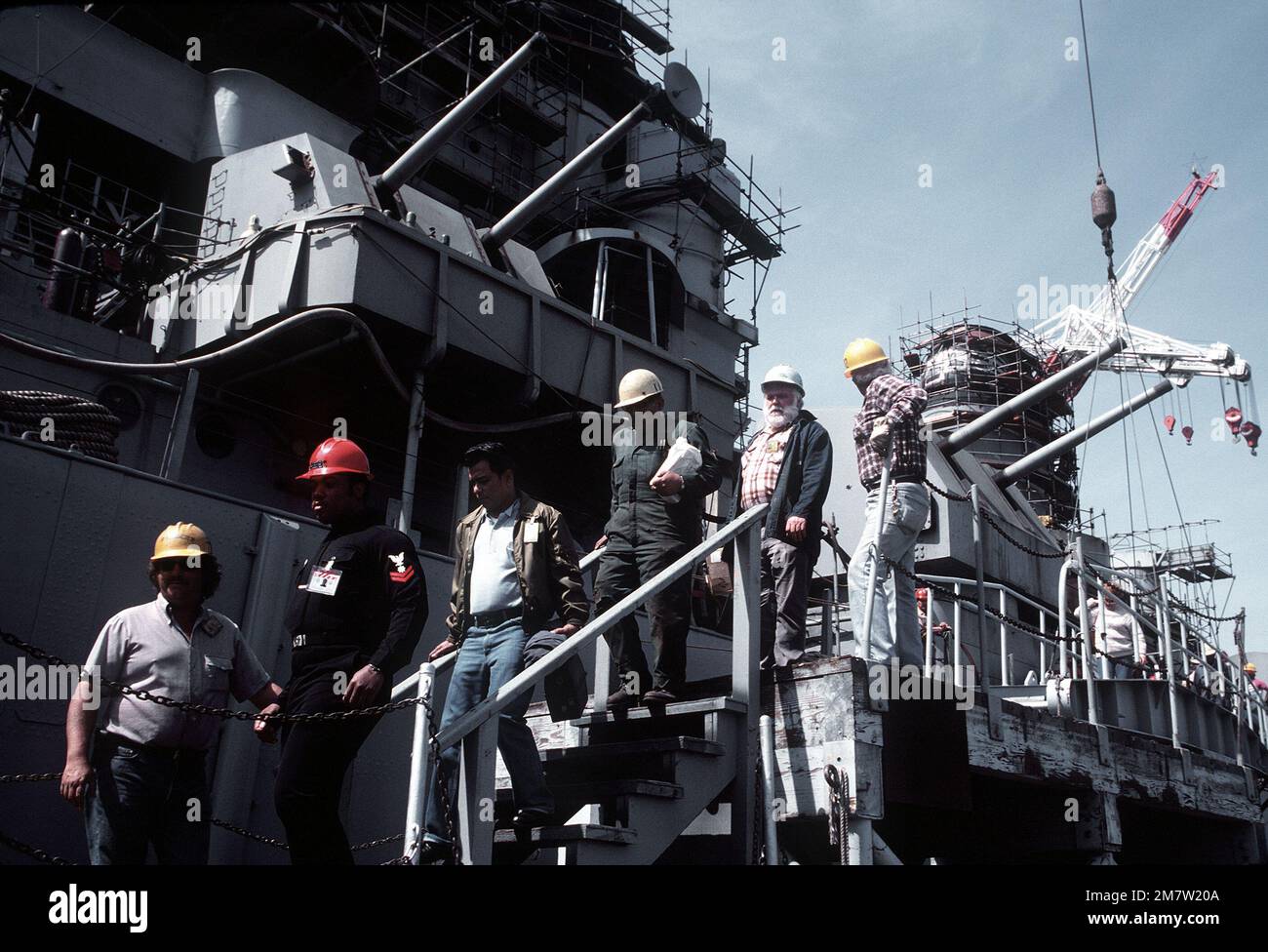 Naval shipyard workers come ashore after the battleship NEW JERSEY (BB ...