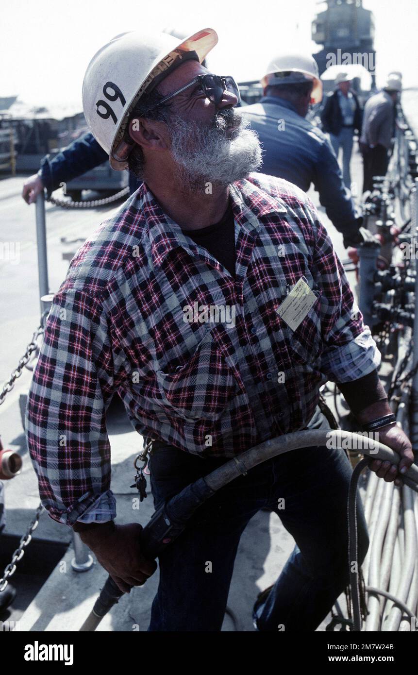A Naval shipyard worker keeps an eye on the battleship NEW JERSEY (BB ...
