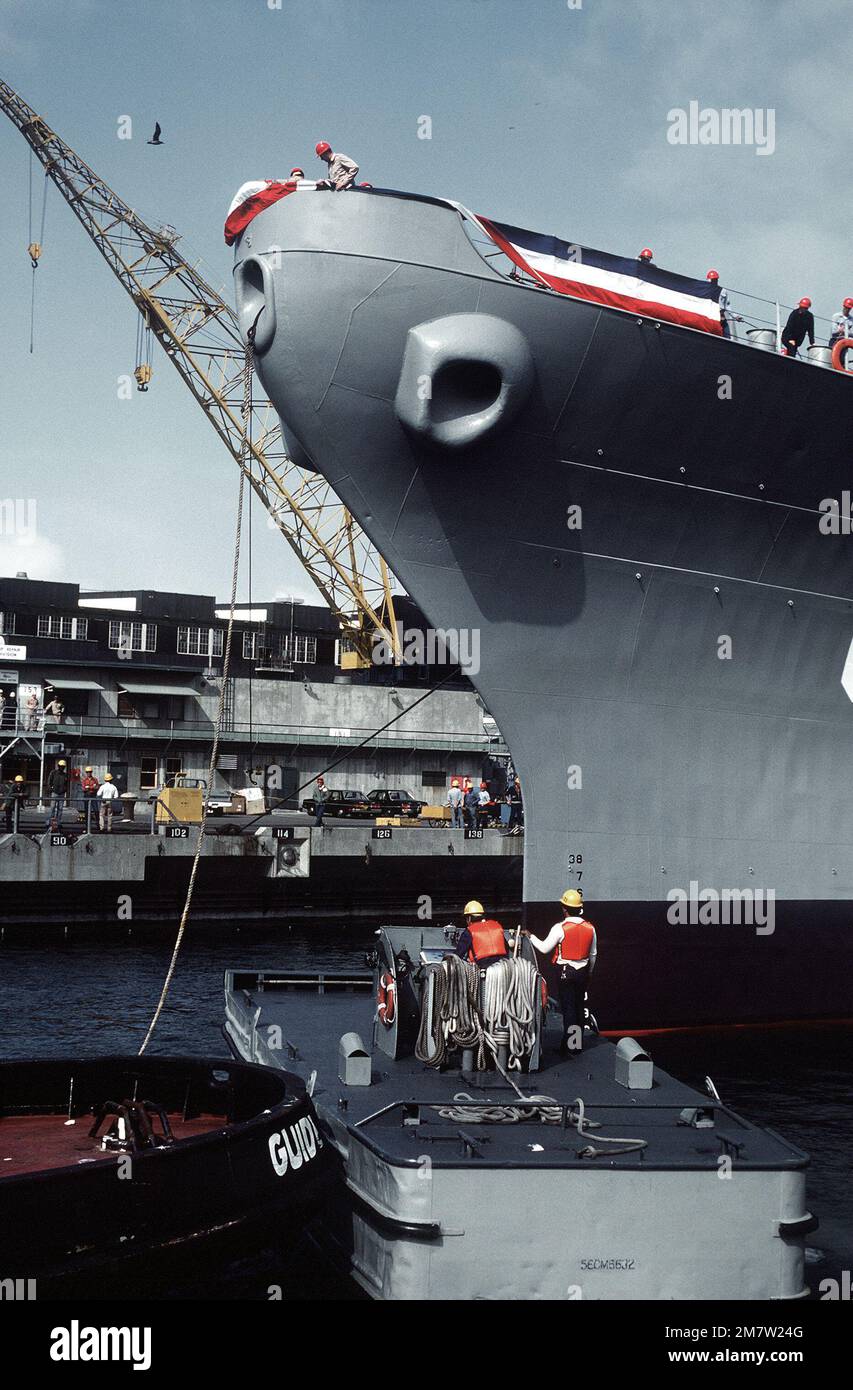 A commercial tugboat gets ready to pull on the bow line as the ...