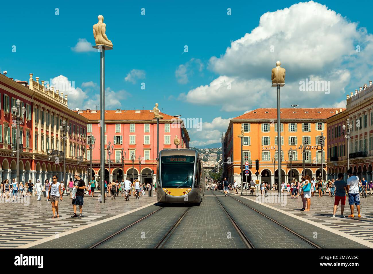 Modern tram and people walking at Place Massena - famous and popular ...