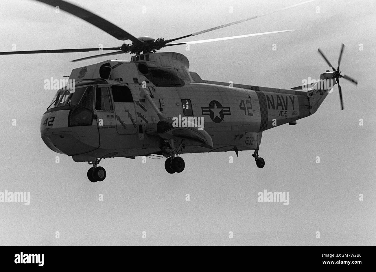 An air-to-air left front view of an SH-3 Sea King helicopter from Fleet ...