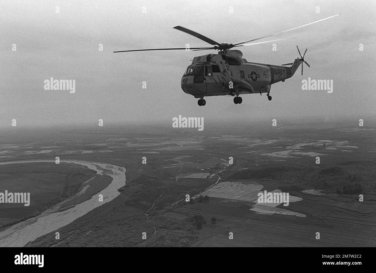 An air-to-air left front view of an SH-3 Sea King helicopter from Fleet ...