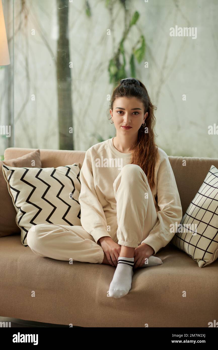 Young woman in comfy loungewear resting on sofa at home Stock Photo - Alamy
