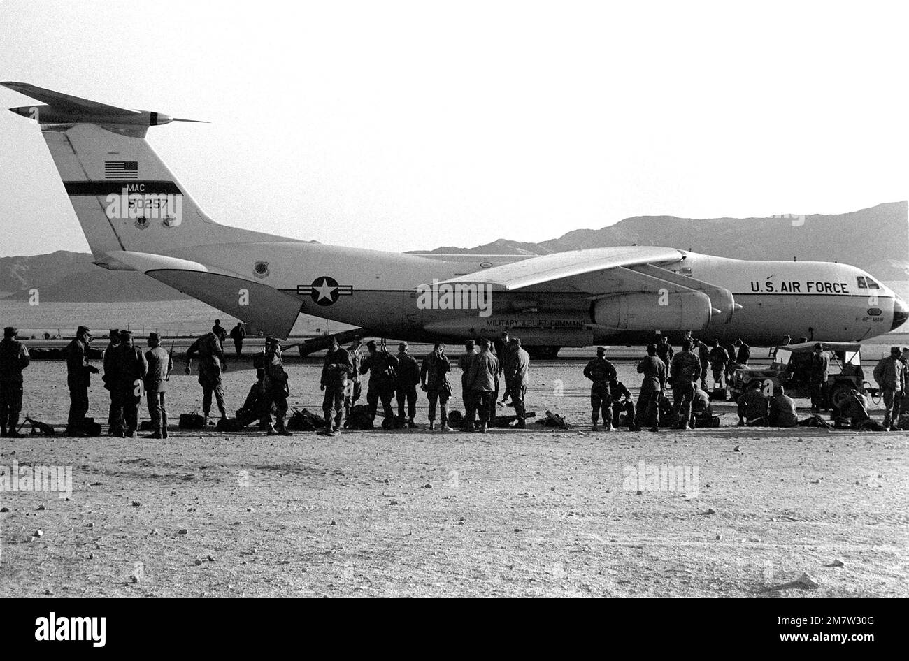 Men from the 2nd Marine Division line up to board a Military Airlift ...