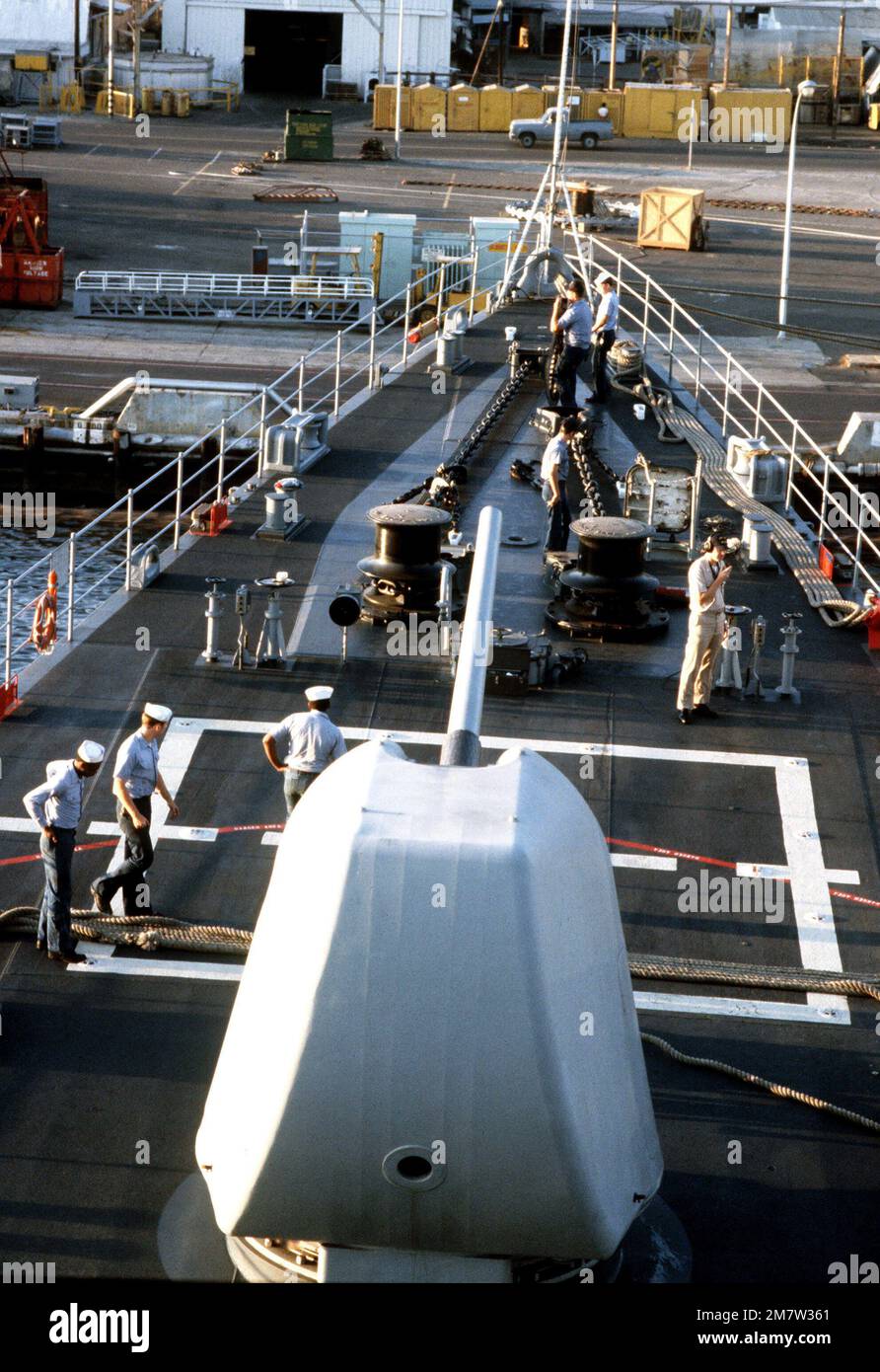 Crewmen work bow lines aboard the destroyer USS FIFE (DD 991) as the ...