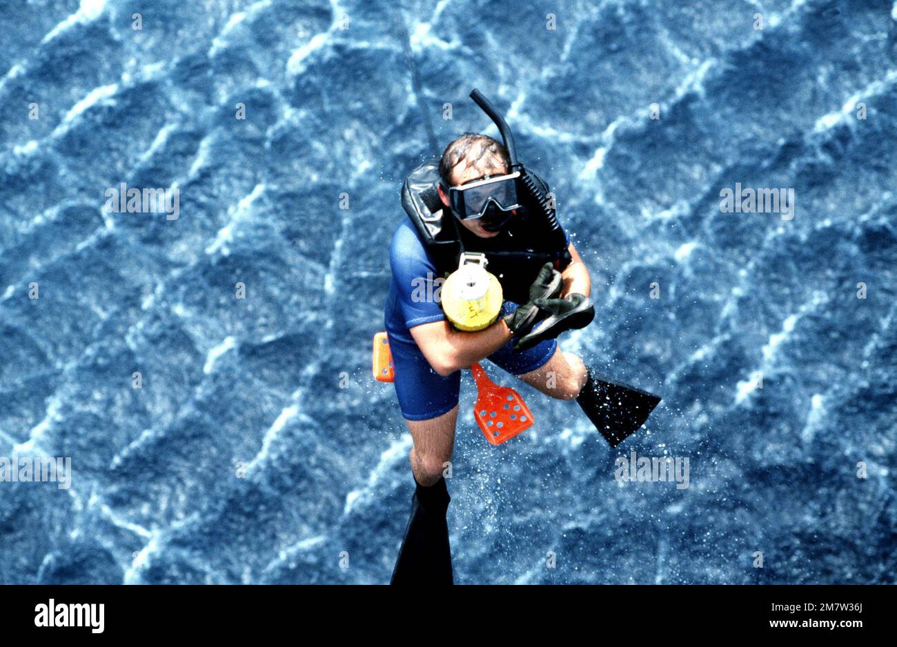 A Sea-Air-Rescue (SAR) crewman is hoisted aboard a CH-46 Sea Knight ...