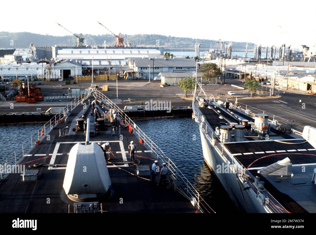Crewmen work bow lines aboard the destroyer USS FIFE (DD 991) as the ...
