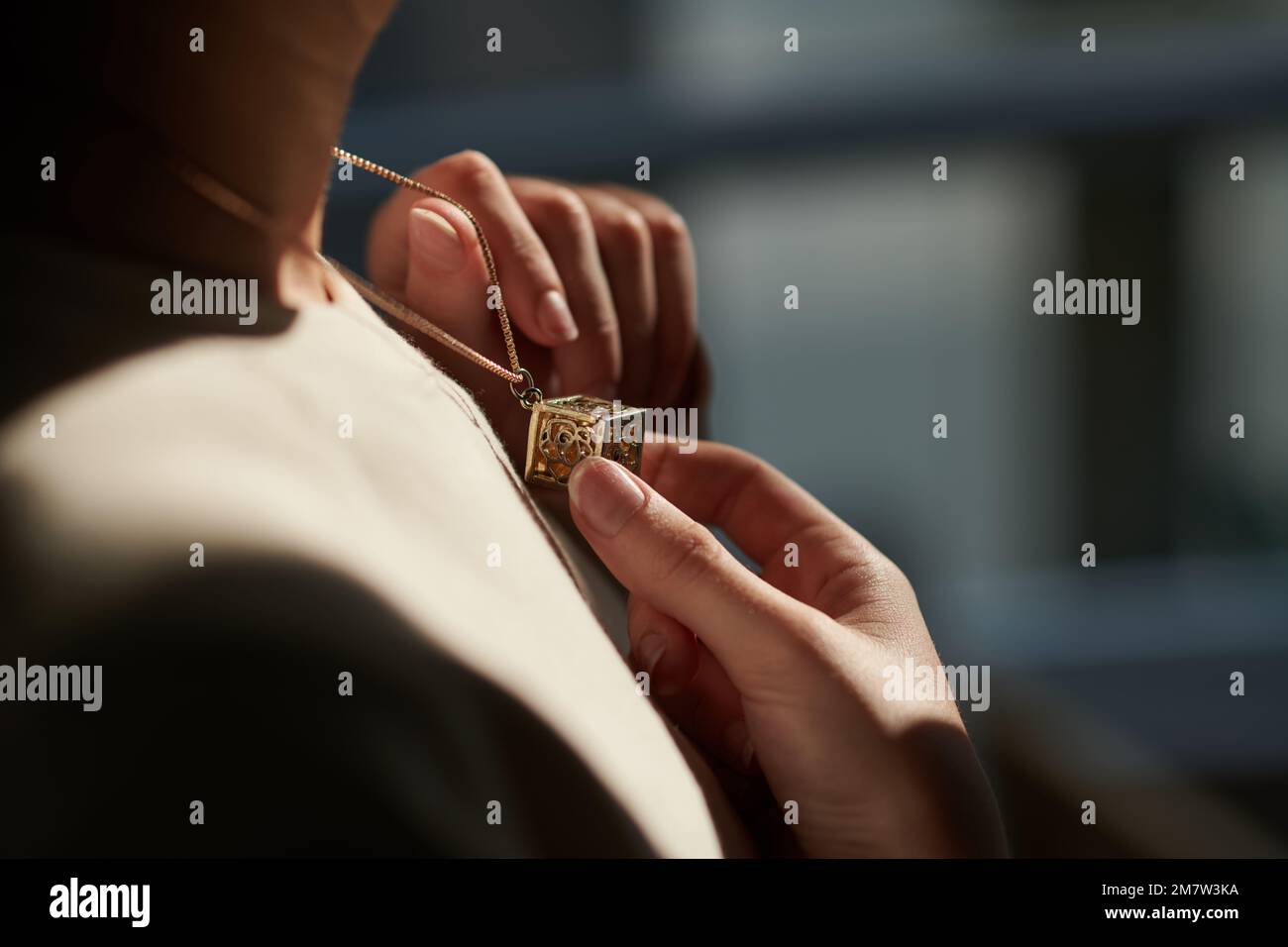 Closeup image of young woman wearing golden pedant for event Stock ...