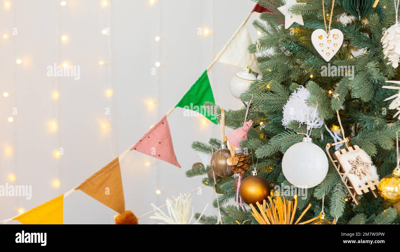 Christmas tree decorated with golden ball toys on a blurry, sparkling ...