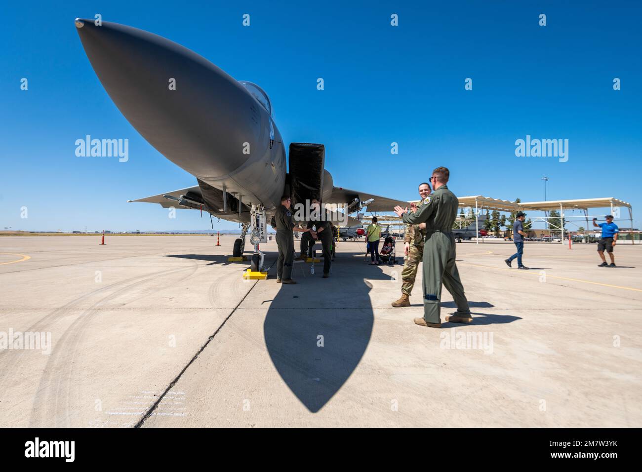U.S. Air Force pilots talk beneath an F-15C Eagle fighter jet, assigned ...