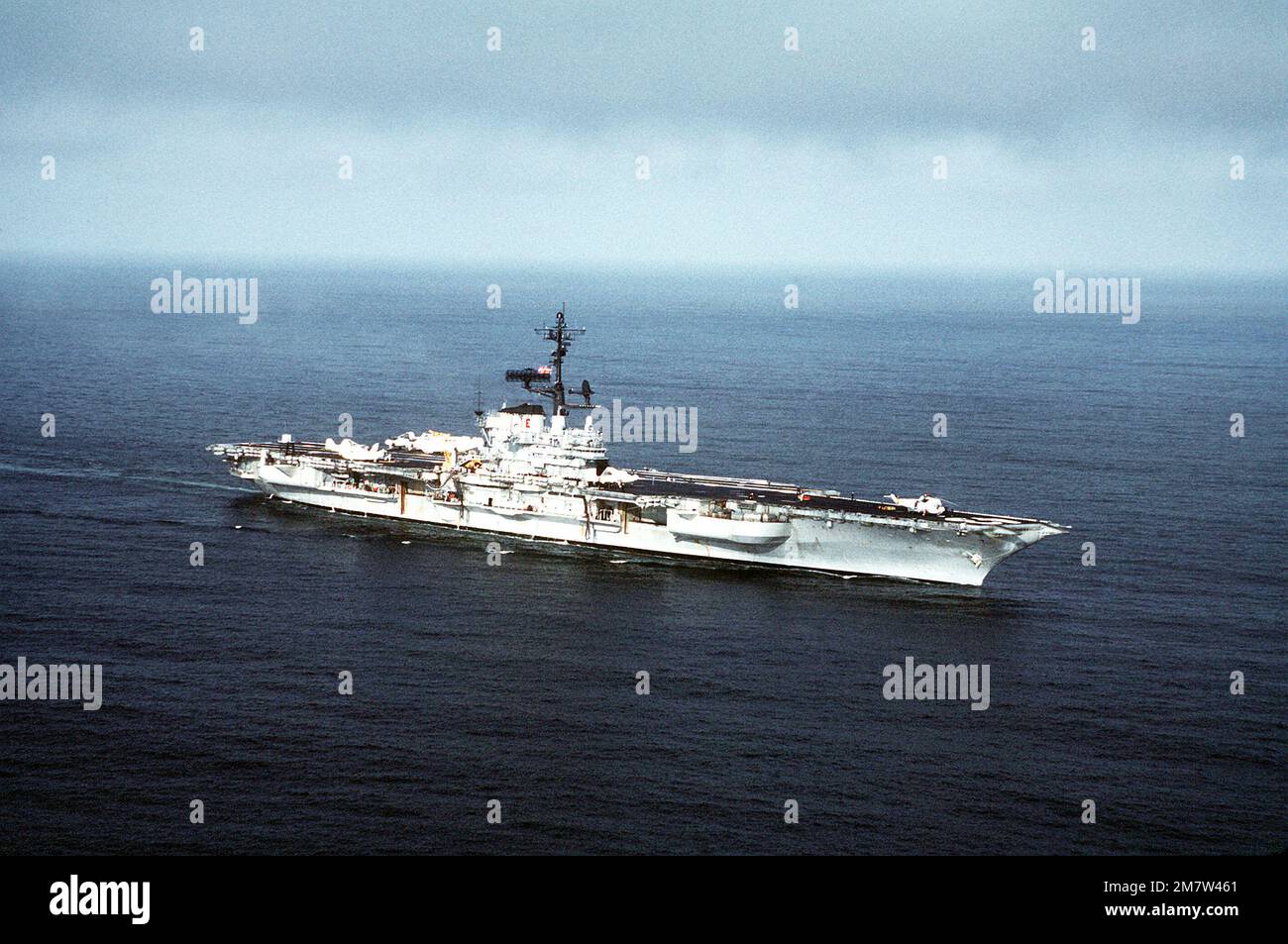 A starboard view of the aircraft carrier USS CORAL SEA (CV-43) underway. The carrier is ...