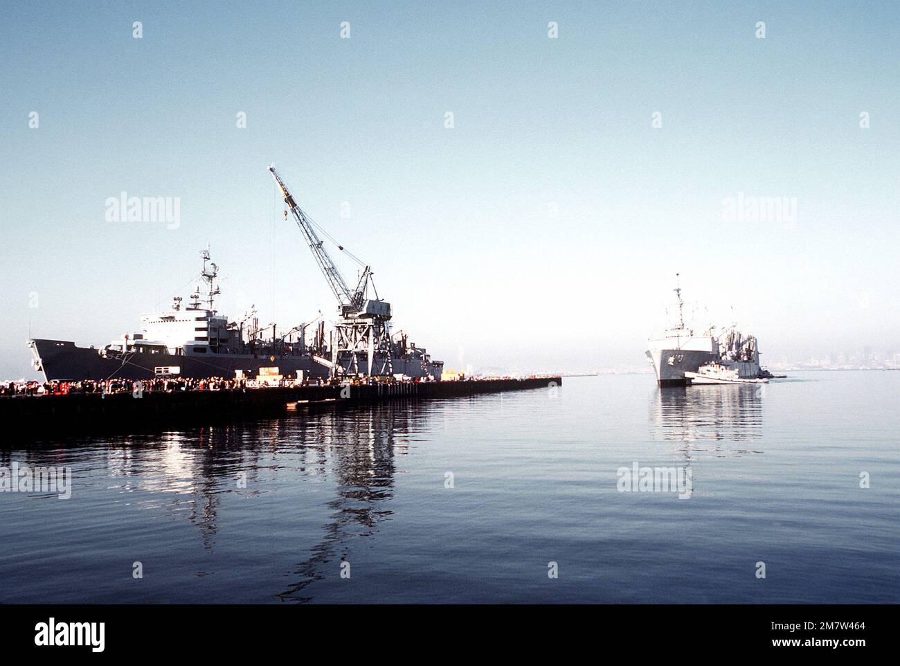 The large harbor tug USS POUGHKEEPSIE (YTB-813) assists the ...