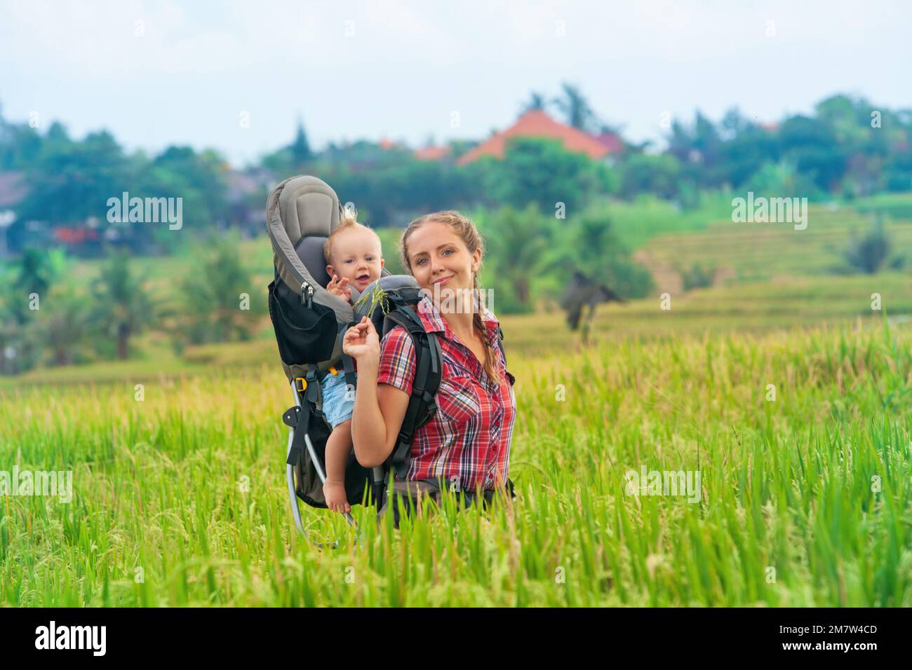 Nature walk in green rice terrace field. Happy mother hold little ...