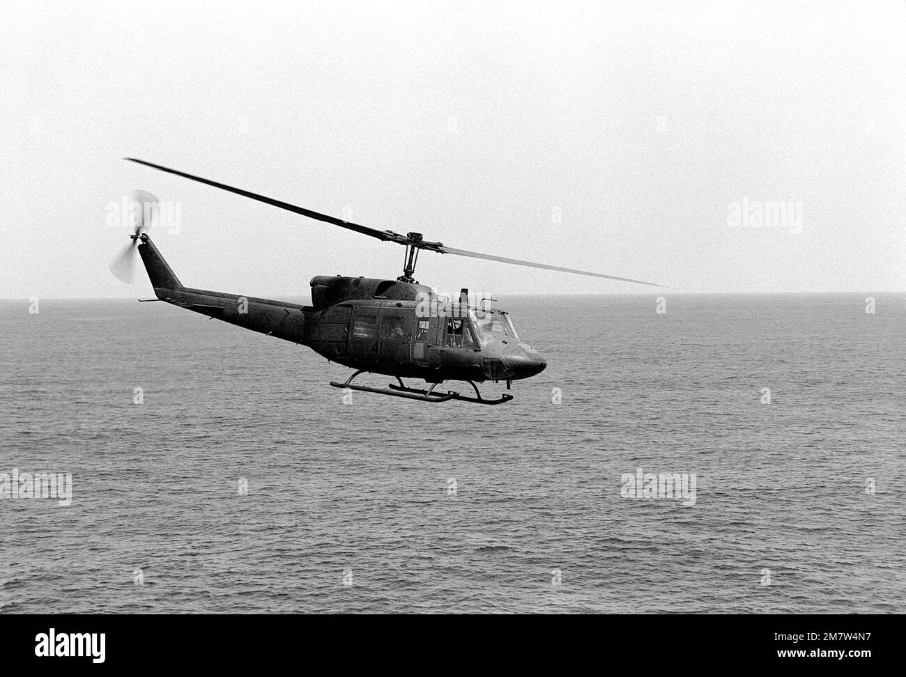 A UH-1N Iroquois helicopter after take off from the deck of the ...