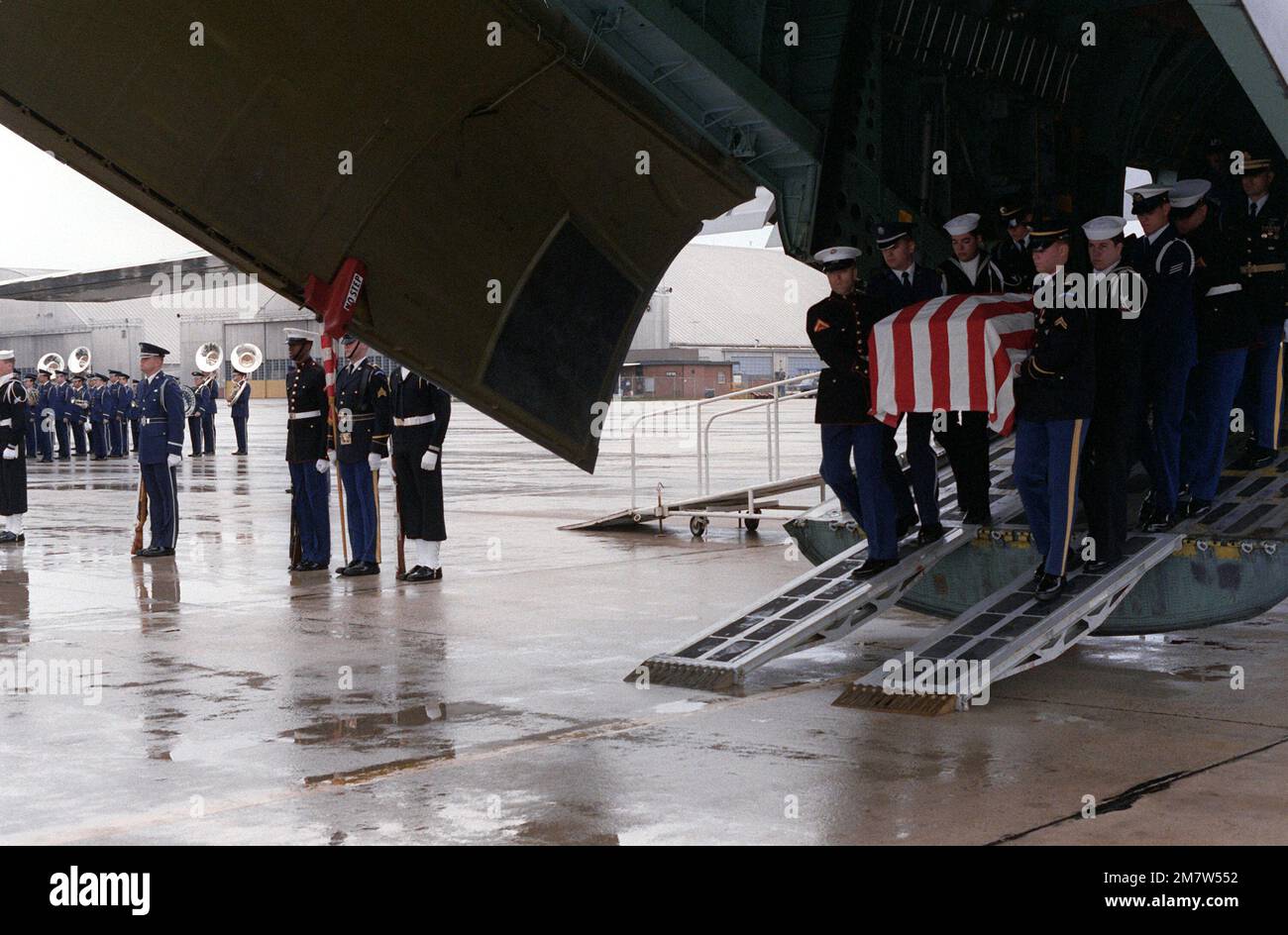 The remains of GEN Nathan F. Twining are being carried from a C-141 ...