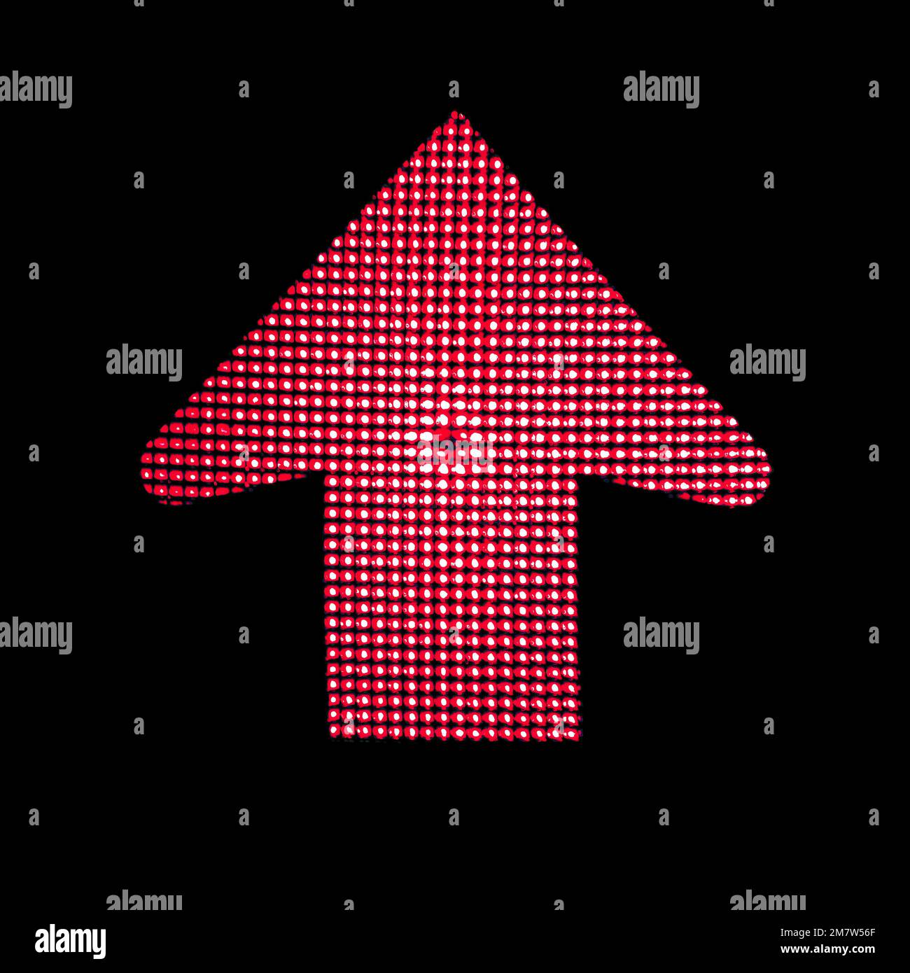 Wrong direction. Red arrow light on traffic lights on black background ...