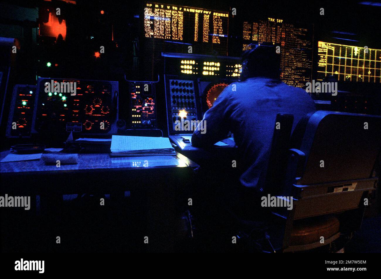 A crewman monitors a radar scope in the combat information center ...
